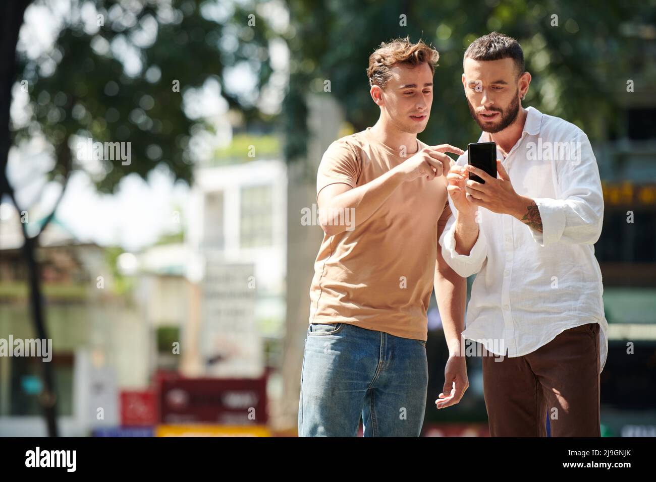 Excited man showing social media profile picture of his new girlfriend ...