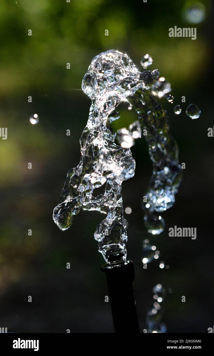Waterdrops levitate on dark background. Water splash in dark with a ...