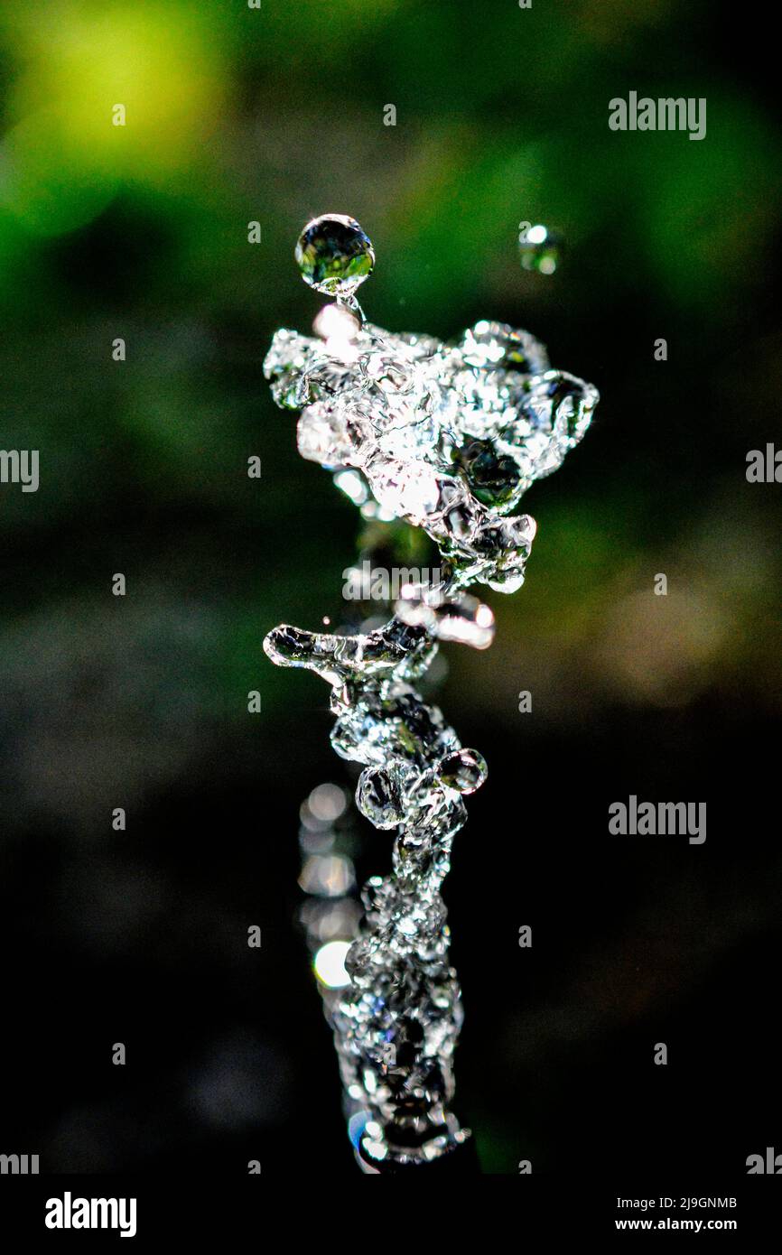 Waterdrops levitate on dark background. Water splash in dark with a ...