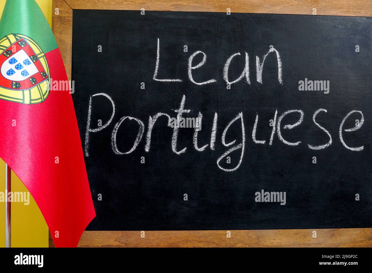 Flag of Portugal and the inscription learn Portuguese on the blackboard ...