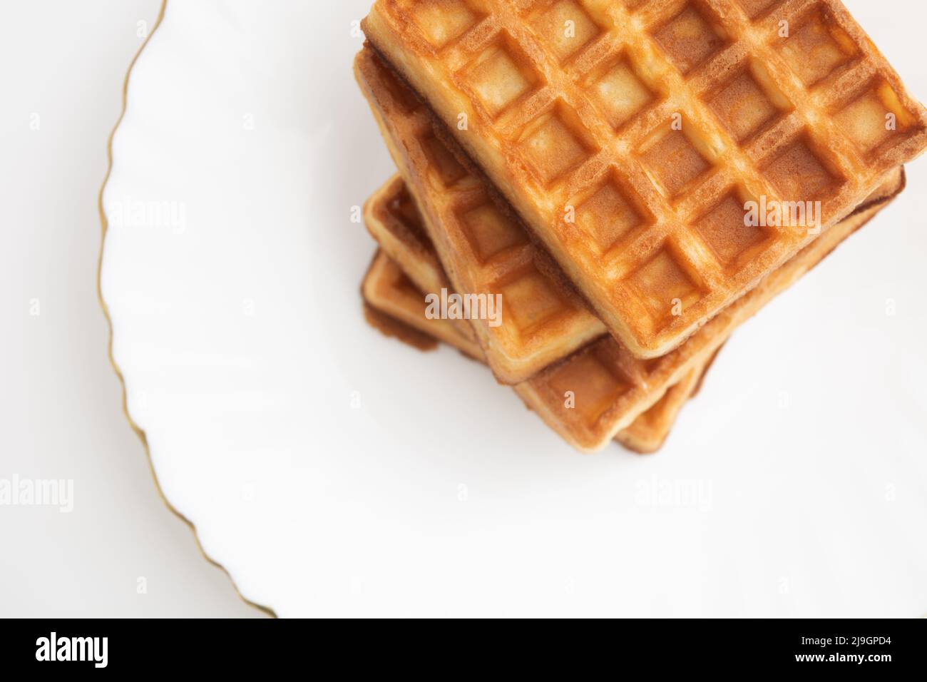 Stack of waffles on white plate with white background. Top view Stock ...