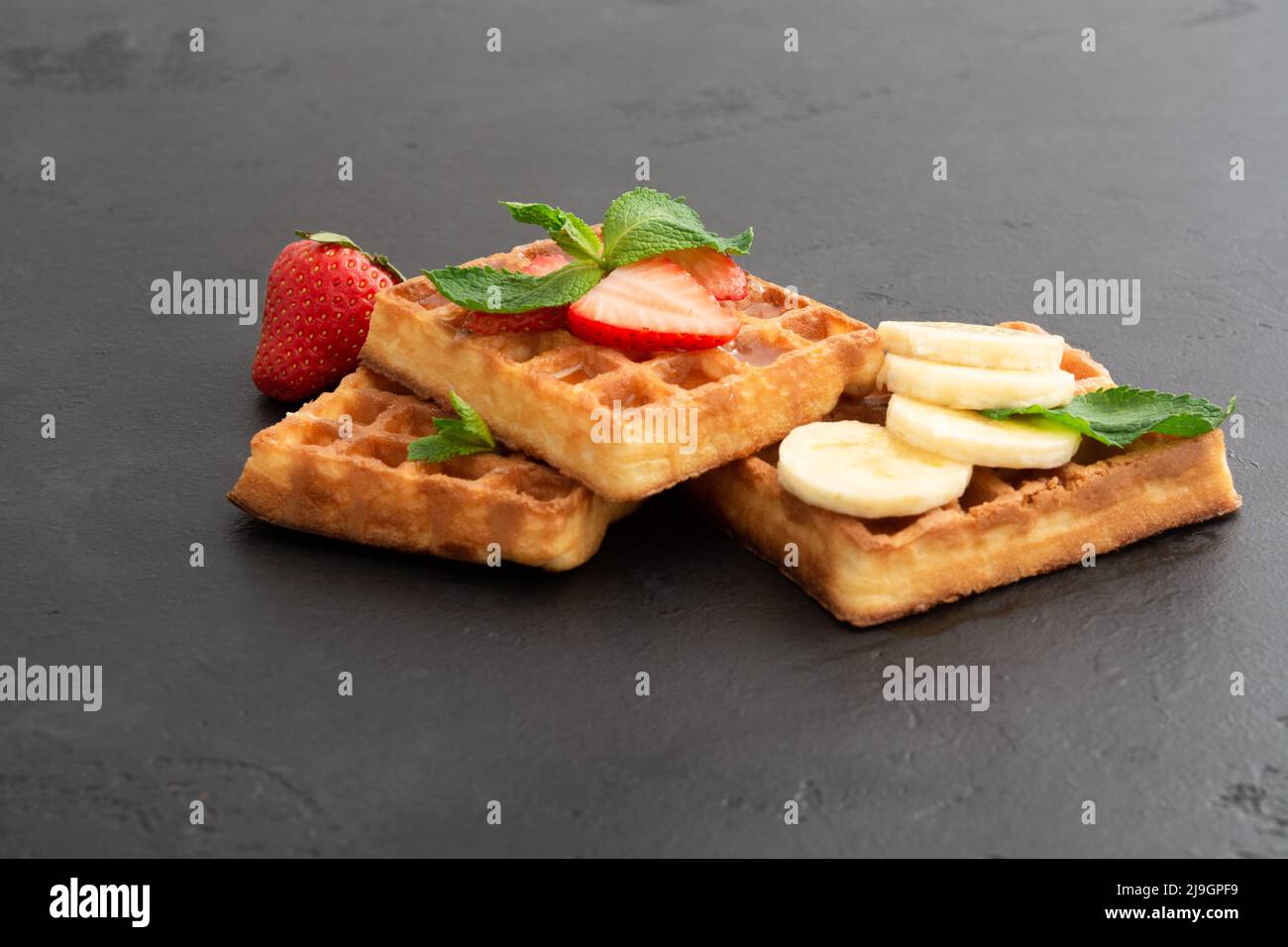 Closeup view of belgium waffles with different fruits and berries Stock ...