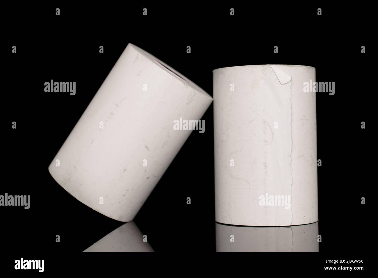 Two rolls of paper cash register tape, close-up isolated on black Stock ...