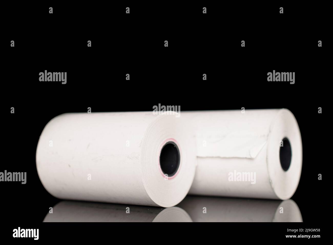 Two rolls of paper cash register tape, close-up isolated on black Stock ...