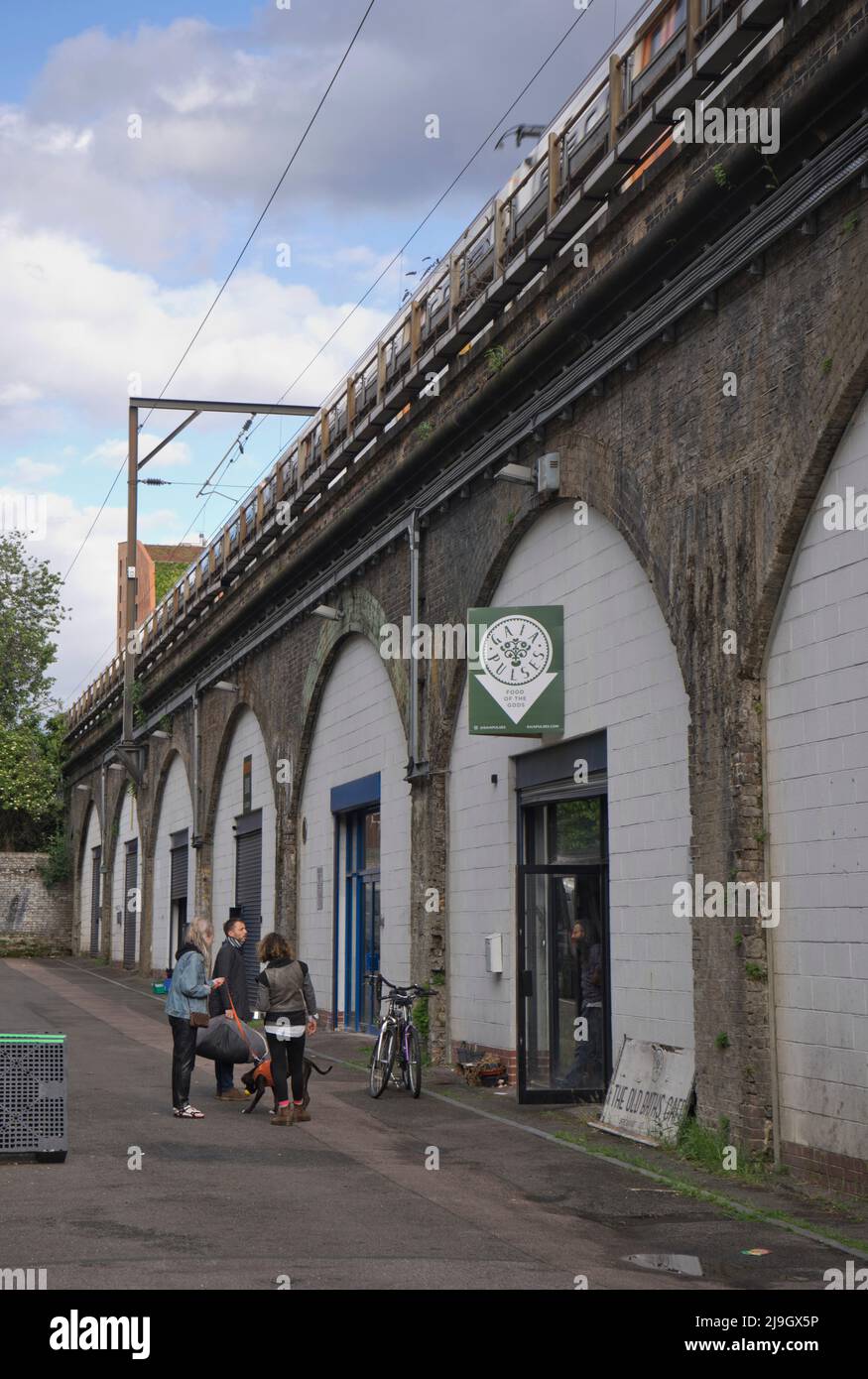 Small business redeveloped under railway arches by train and overground ...
