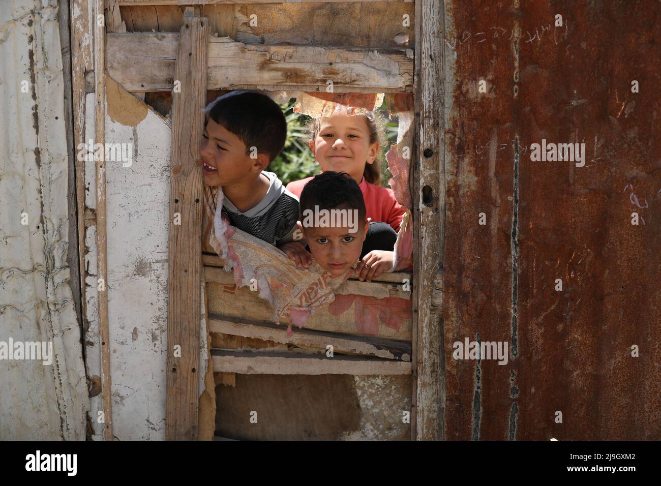 Palestinian children play near their house in a slum in Beit Hanoun in ...
