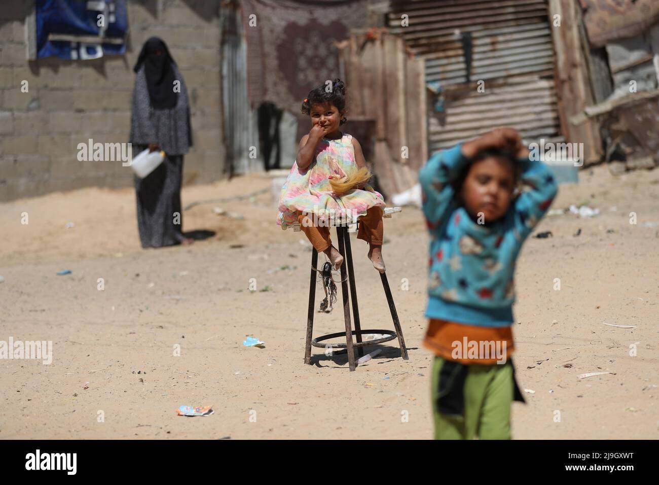 Palestinian children play near their house in a slum in Beit Hanoun in ...