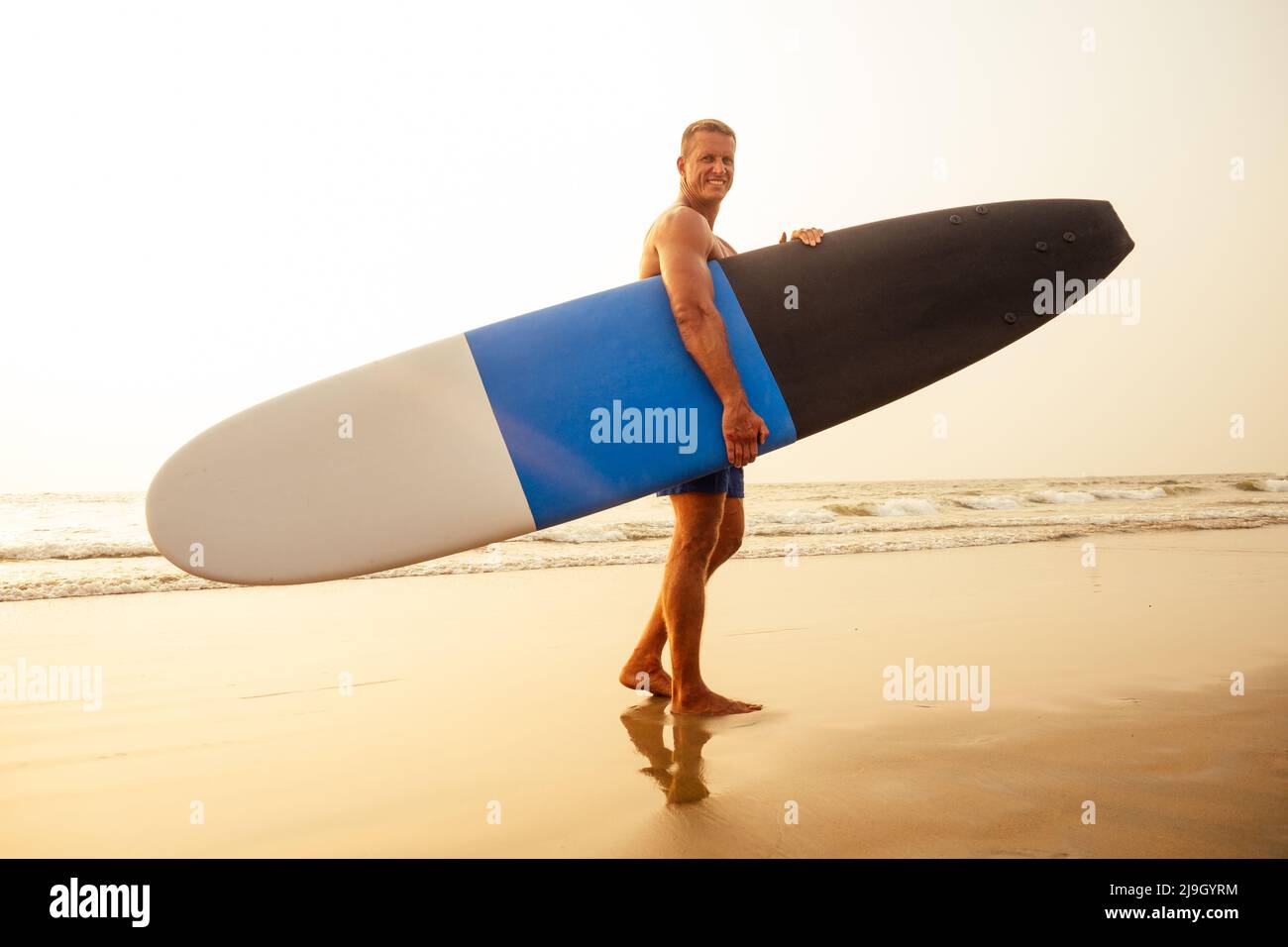 surfing freelancing man muscle and press sport training on the beach at ...