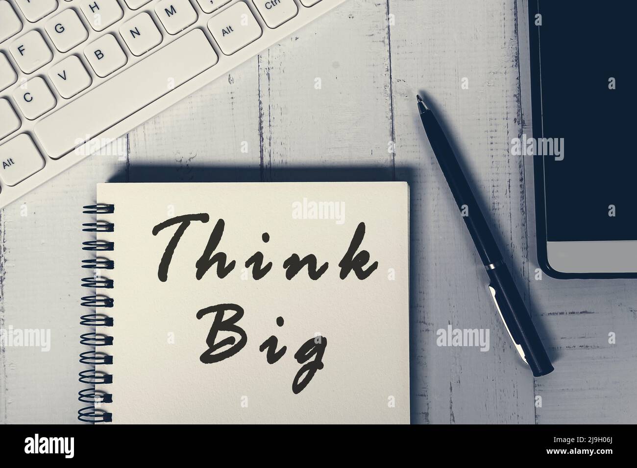 Think big word on a notebook with white keyboard, pen, notepad and ...