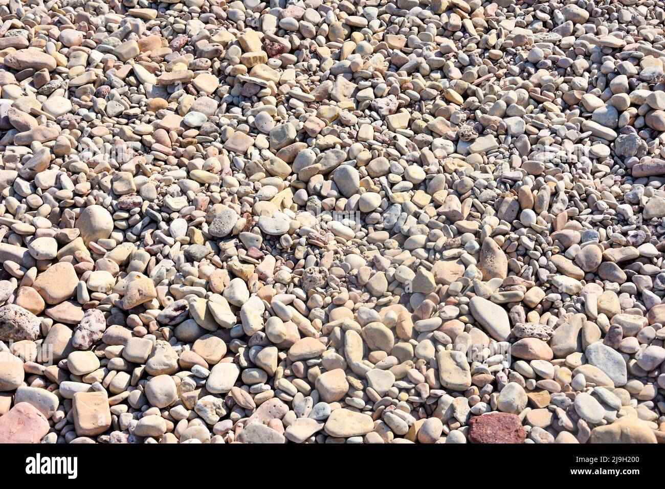 Grey pebbles as a background Stock Photo - Alamy