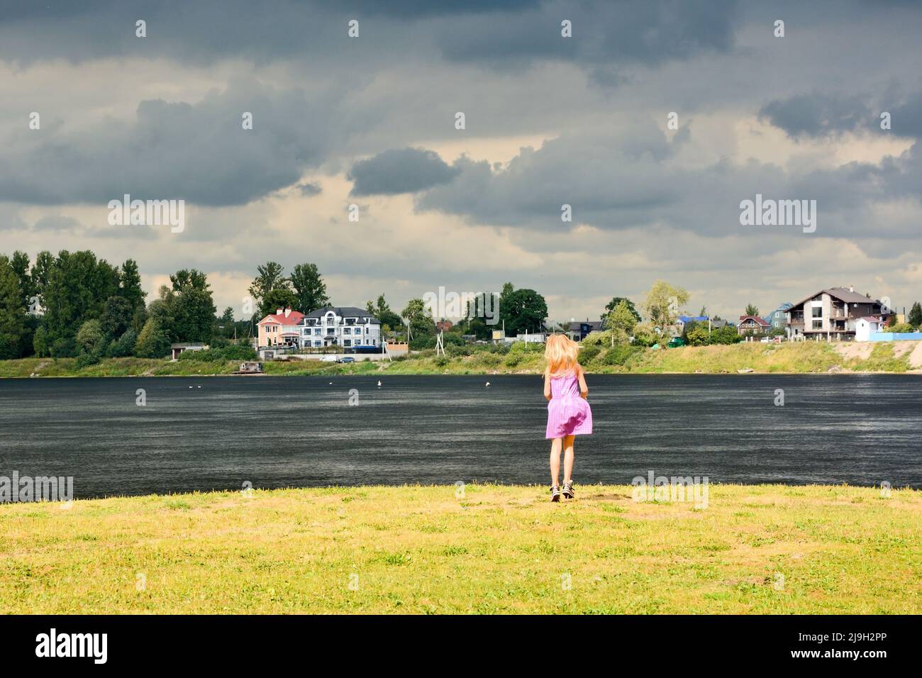 Cute girl on Neva river shore Stock Photo - Alamy