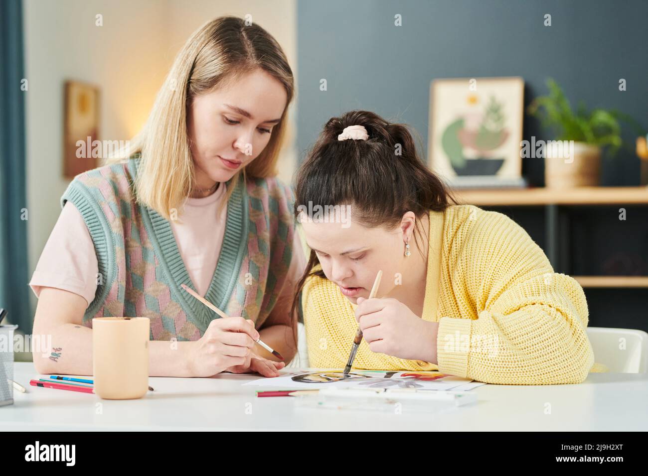 Professional Art teacher having individual class with girl with Down ...