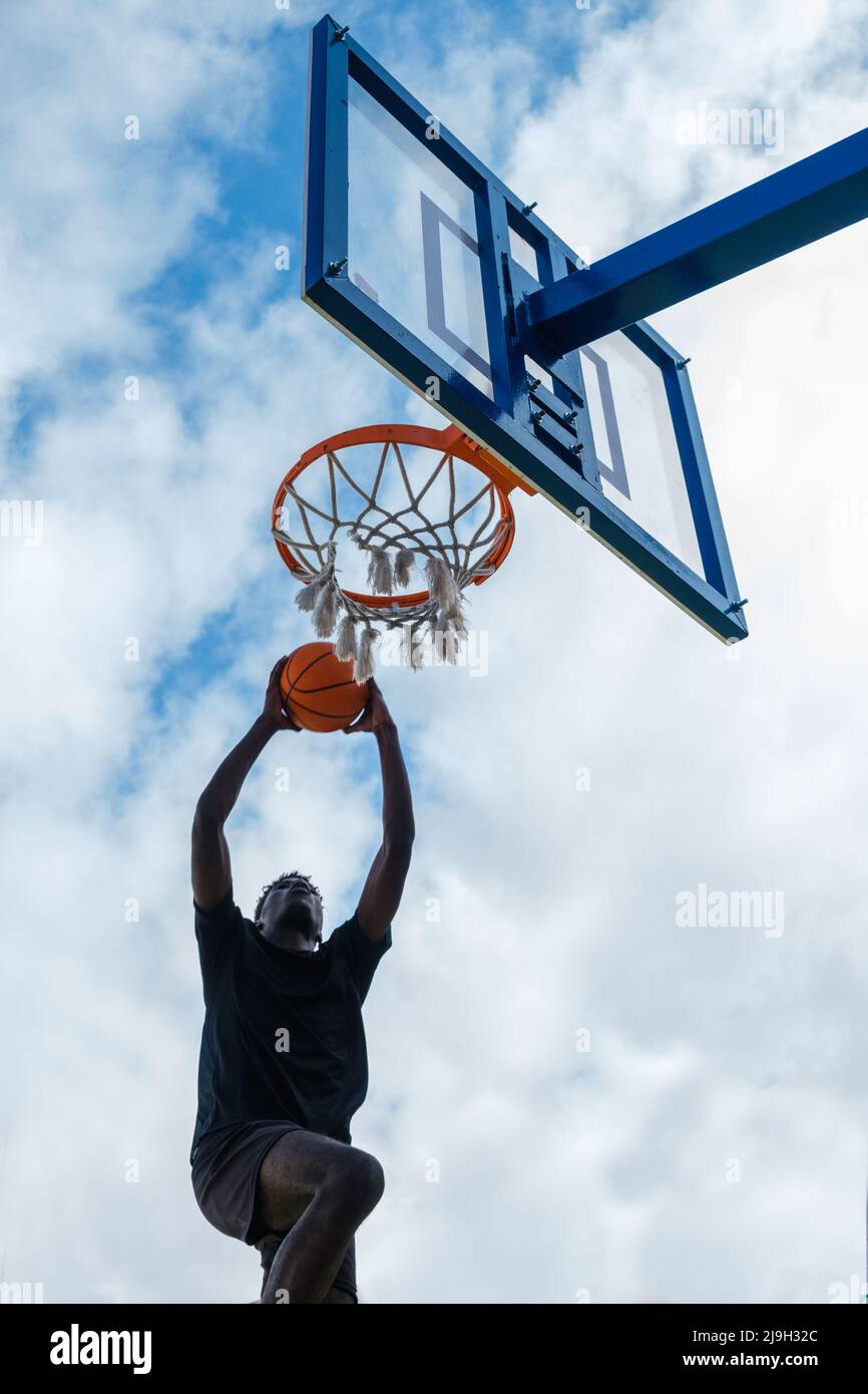 Young man performing a basketball action Stock Photo - Alamy