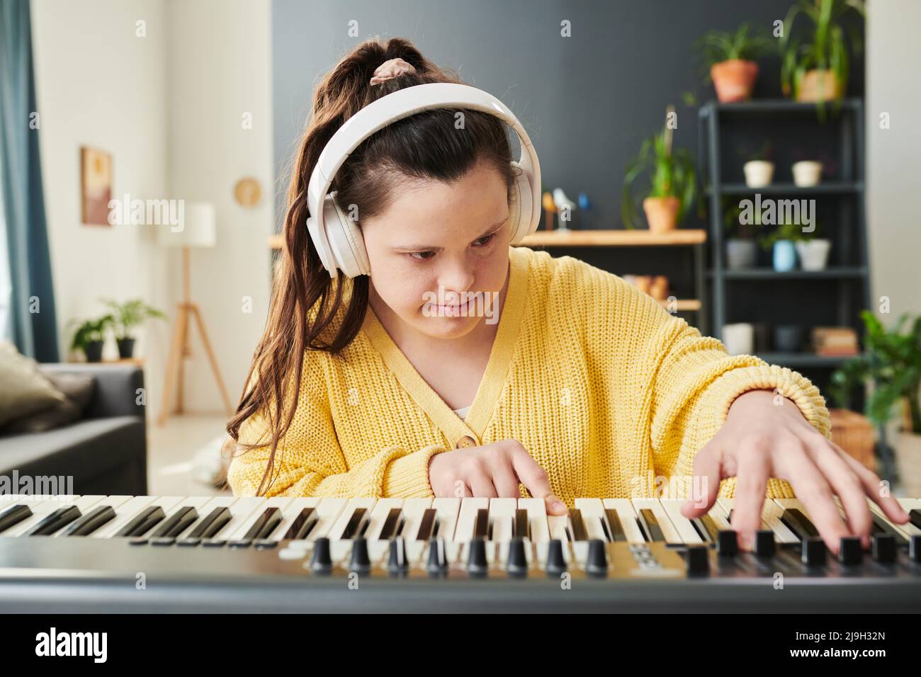Portrait of modern young Caucasian girl with Down syndrome wearing ...