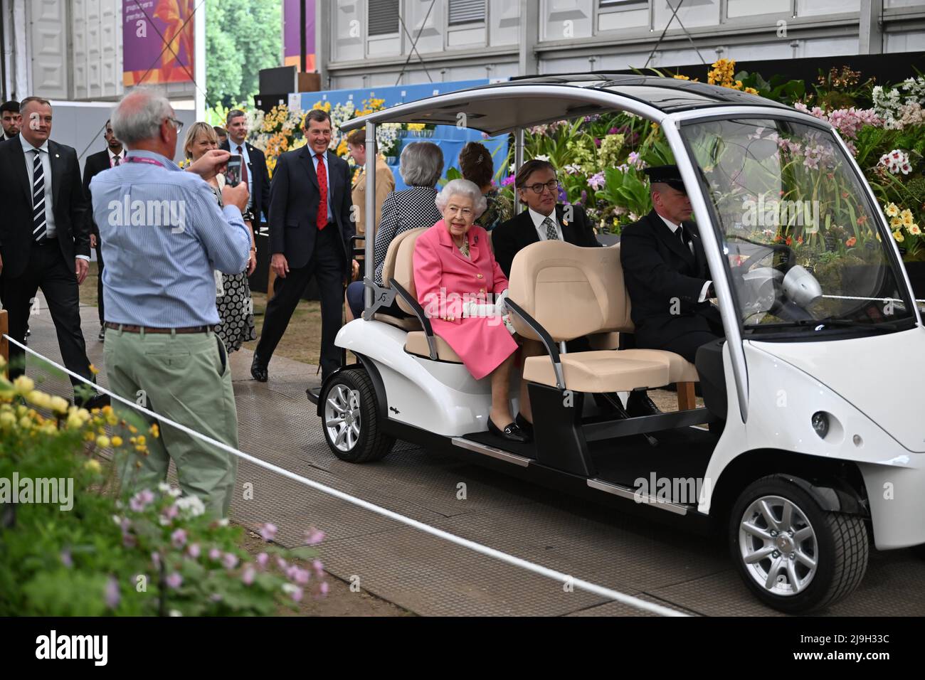 Queen Elizabeth II sitting in a buggy during a visit by members of the ...