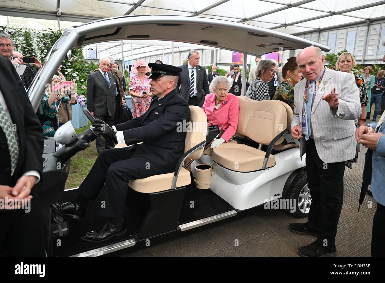 Queen Elizabeth II sitting in a buggy during a visit by members of the ...