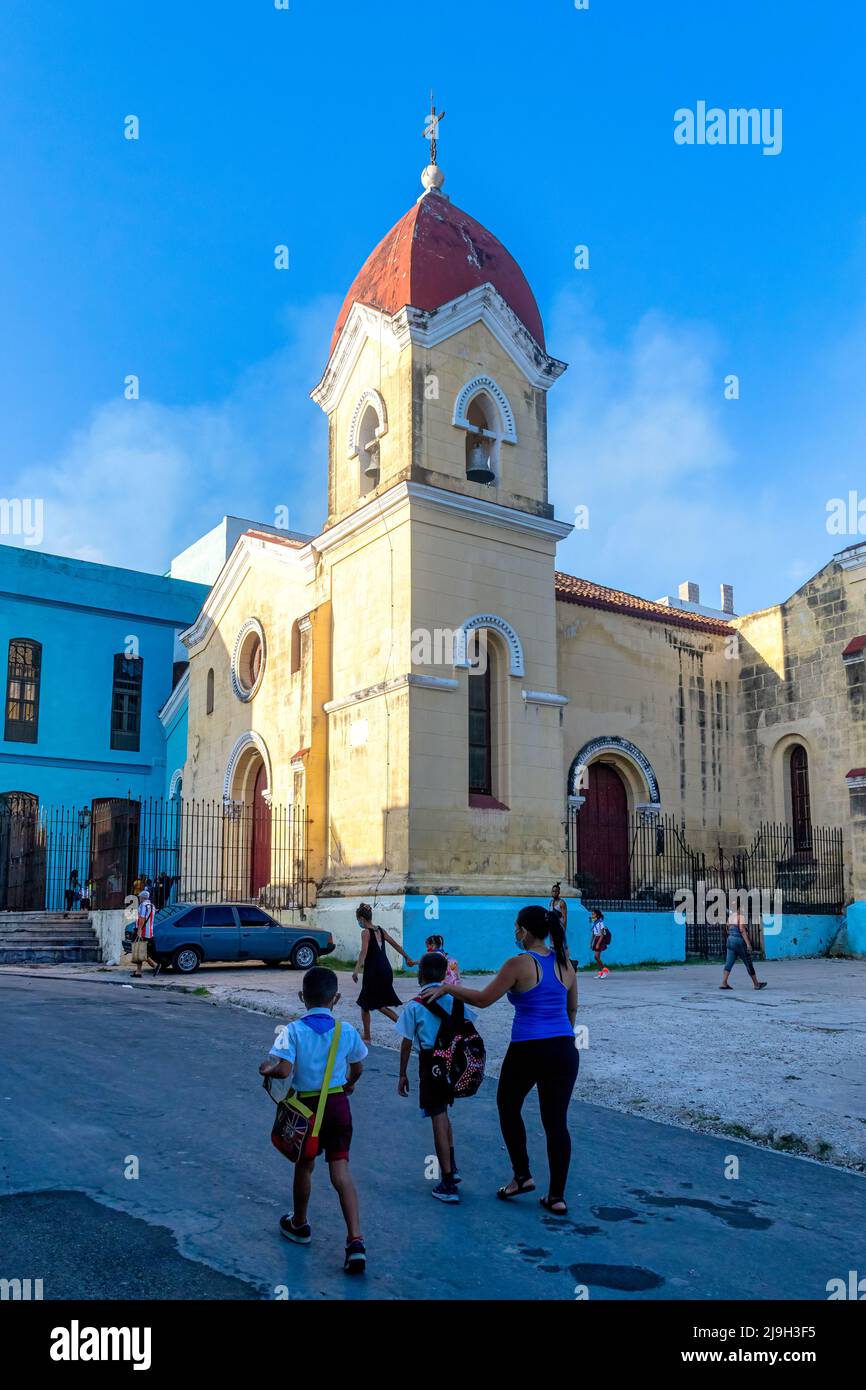 Cuban people walk by the Parroquia de Jesús, María y José which is a ...