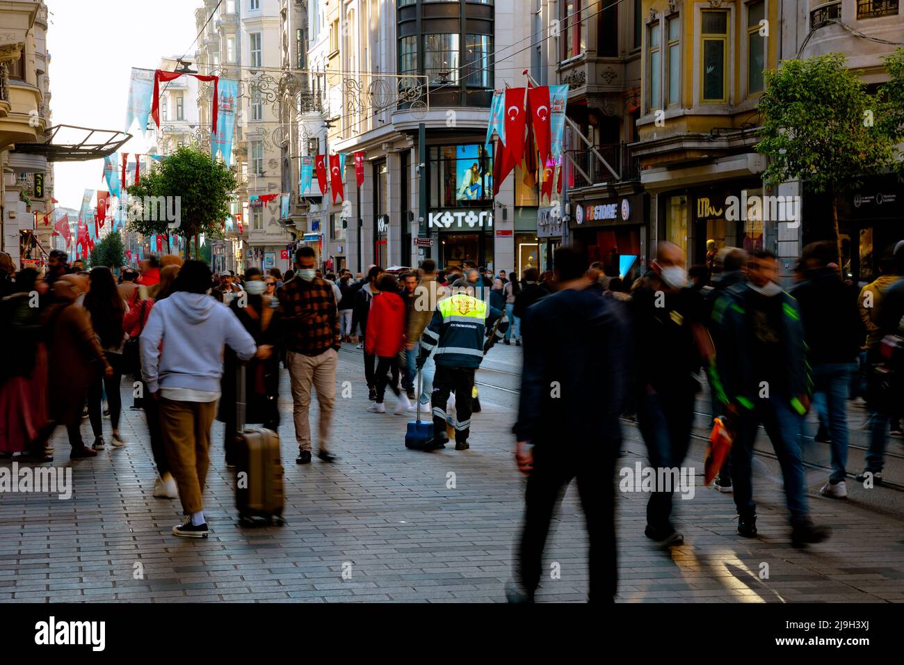 Road sweeper worker and people in Istiklal Caddesi in Istanbul ...