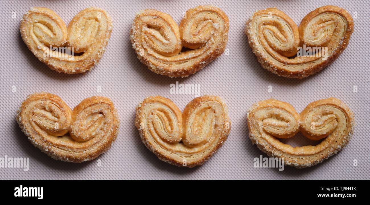 Delicious appetizing cookies with sugar puff pastry top view background ...