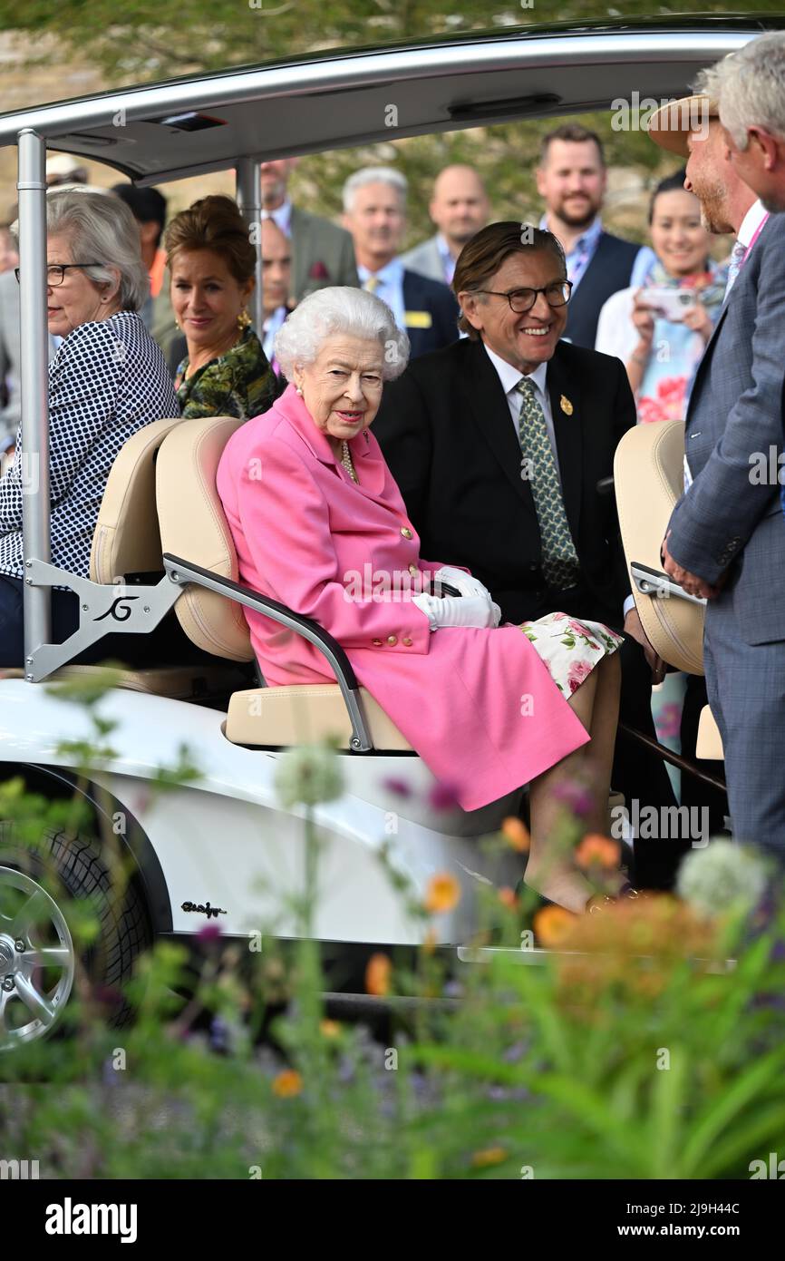 Queen Elizabeth II sitting in a buggy during a visit by members of the ...