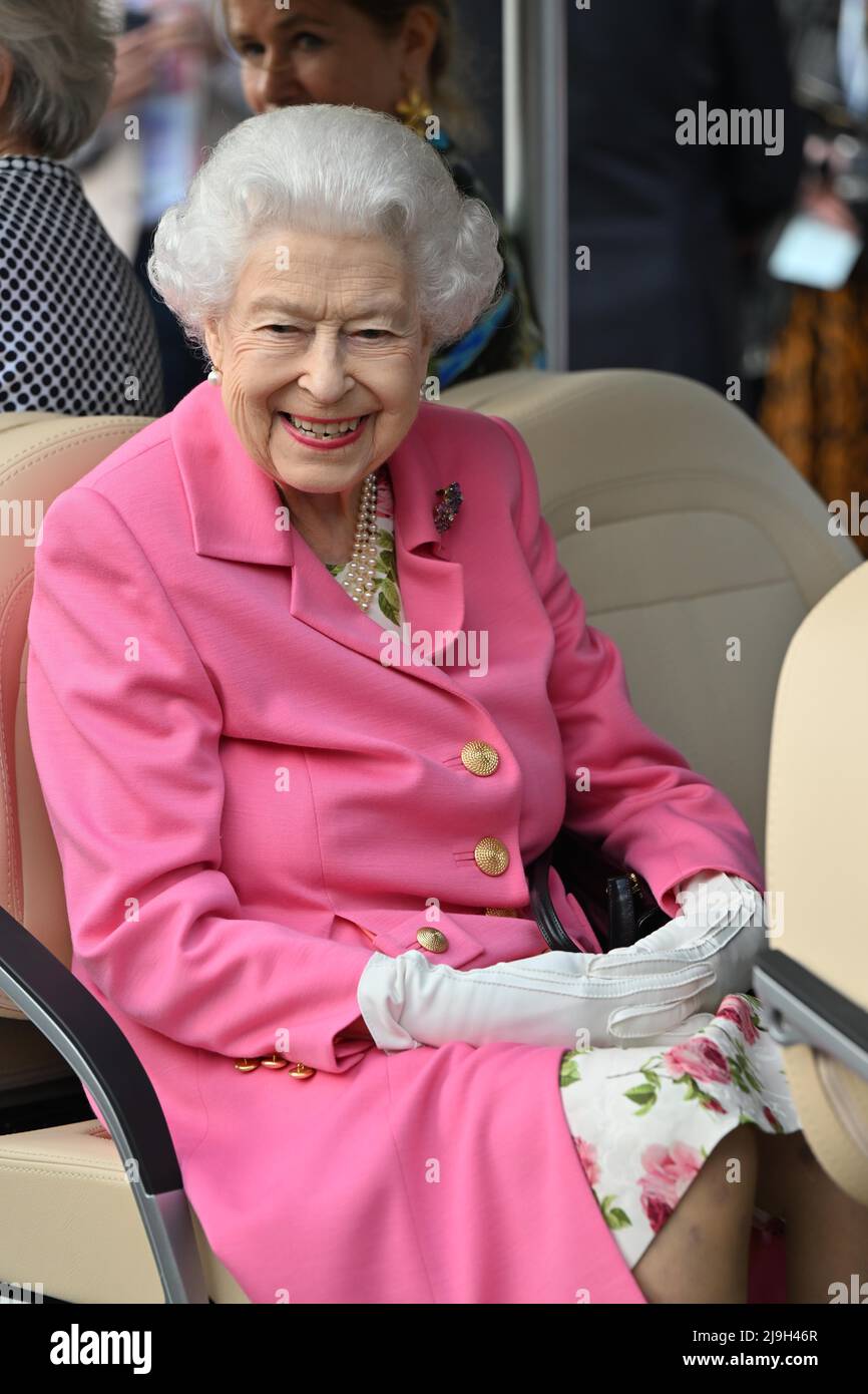 Queen Elizabeth II sitting in a buggy during a visit by members of the ...