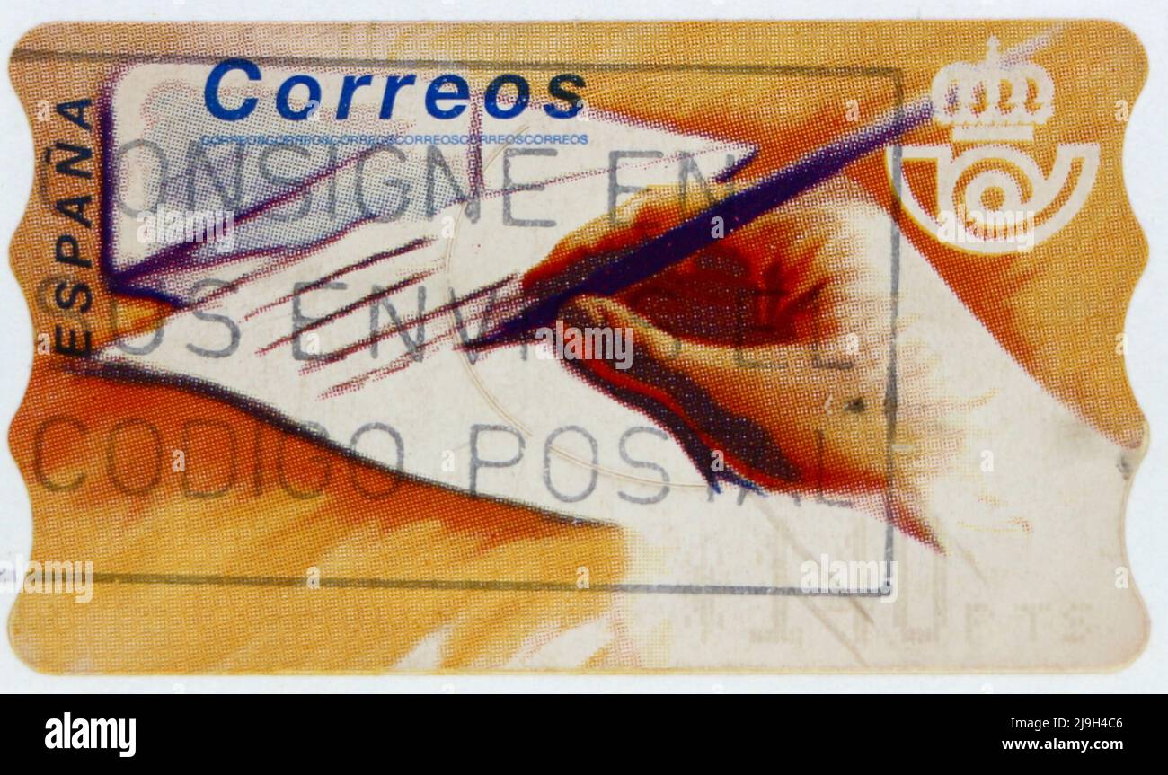 Photo of a Spanish postage stamp with an image of a hand holding a pen ...