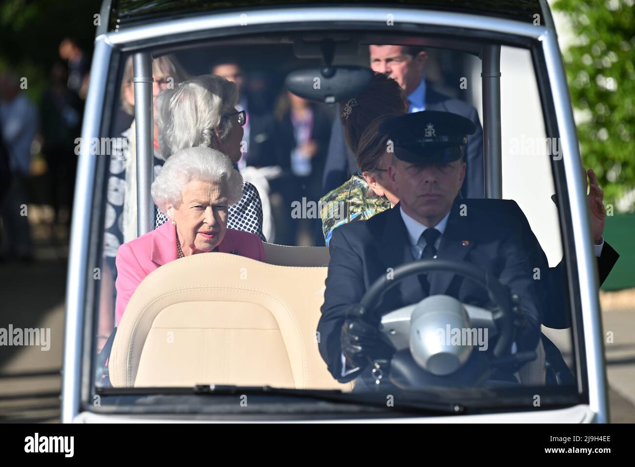 Queen Elizabeth II sitting in a buggy during a visit by members of the ...