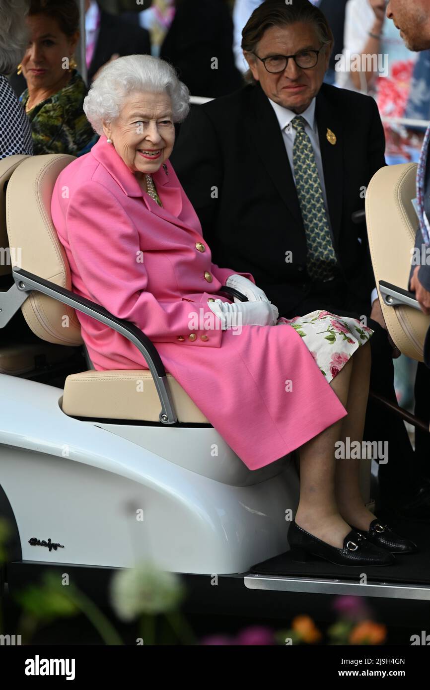 Queen Elizabeth II sitting in a buggy during a visit by members of the ...