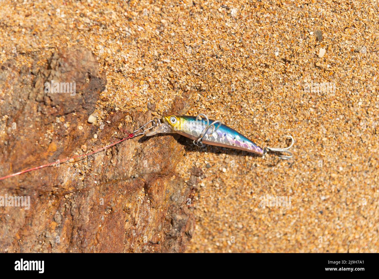 Metal bait for fishing on the ground. Boca do Rio beach in Salvador ...