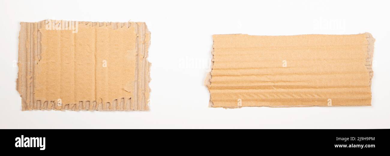 Two pieces of brown corrugated cardboard on white background. Blank ...