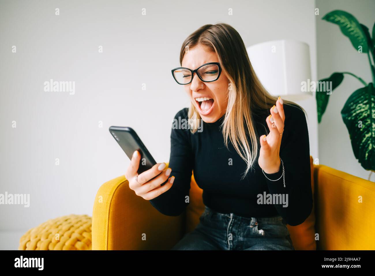 Emotional angry young caucasian woman having video call, screaming and ...