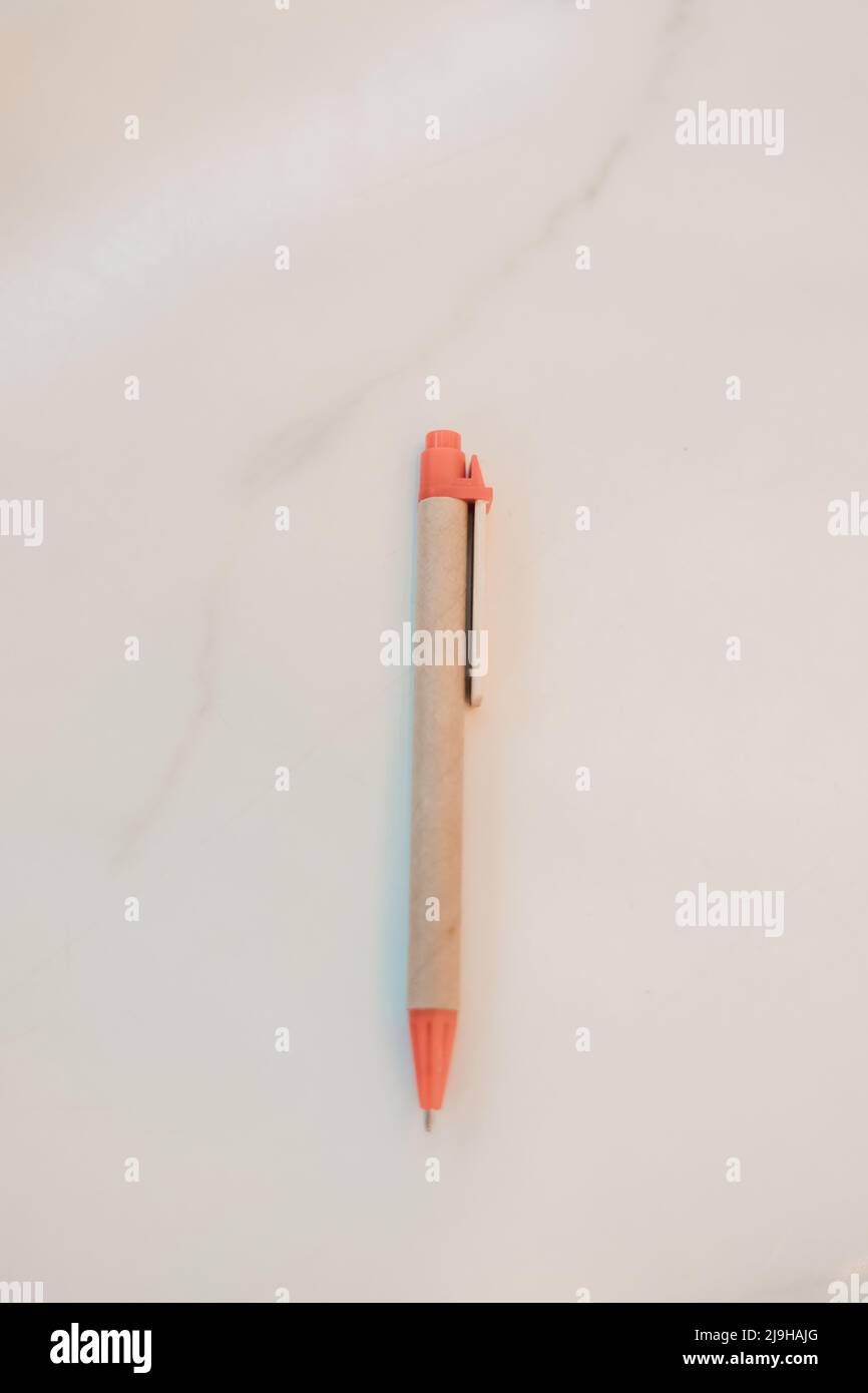 A written pen rests on a white background on the table Stock Photo - Alamy