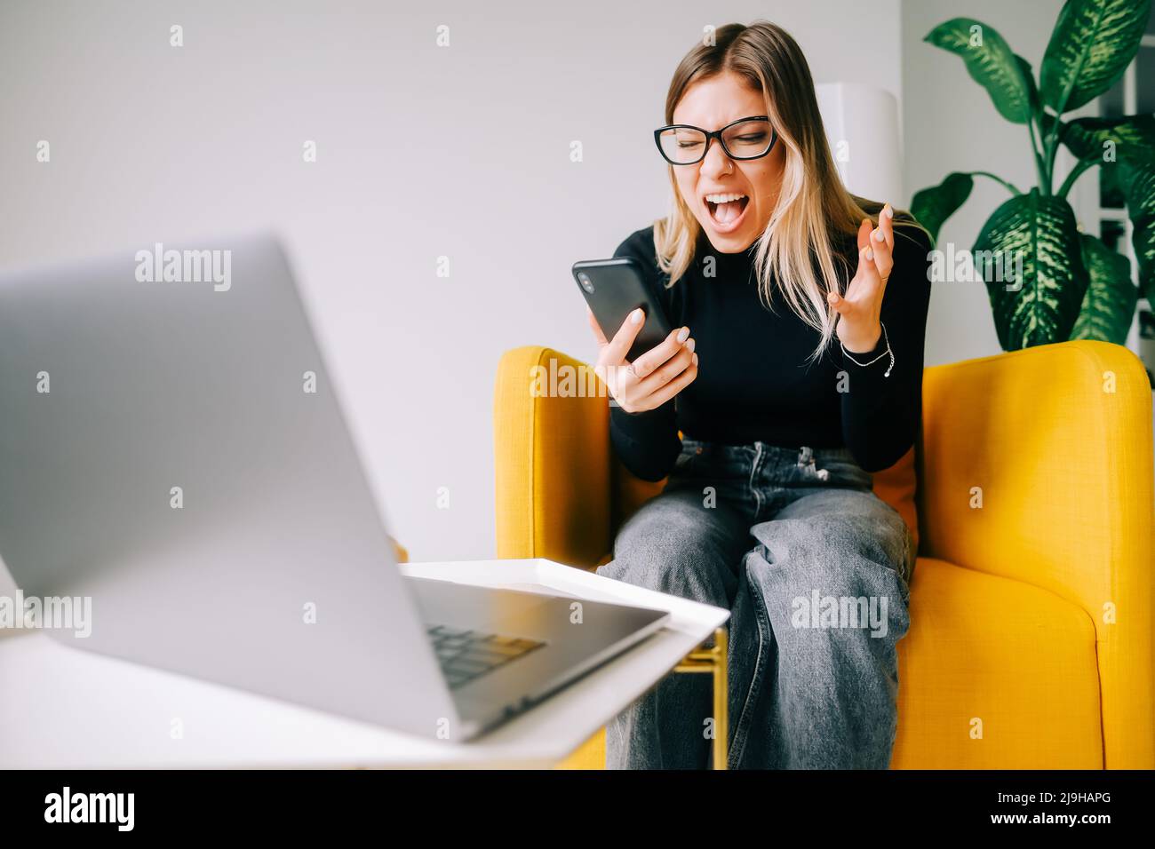 Emotional angry young caucasian woman having video call, screaming and ...