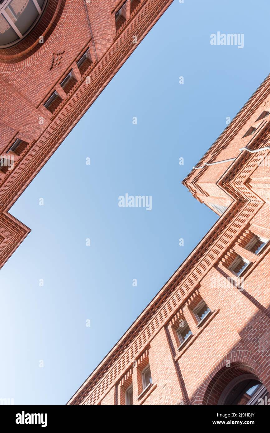 Two modernized brick houses facing each other with blue sky Stock Photo ...