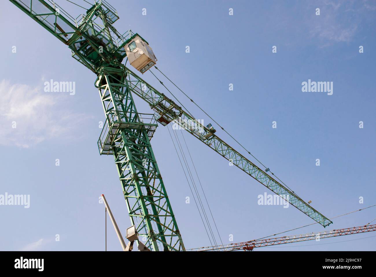 Tower crane against the blue sky view from below Stock Photo - Alamy