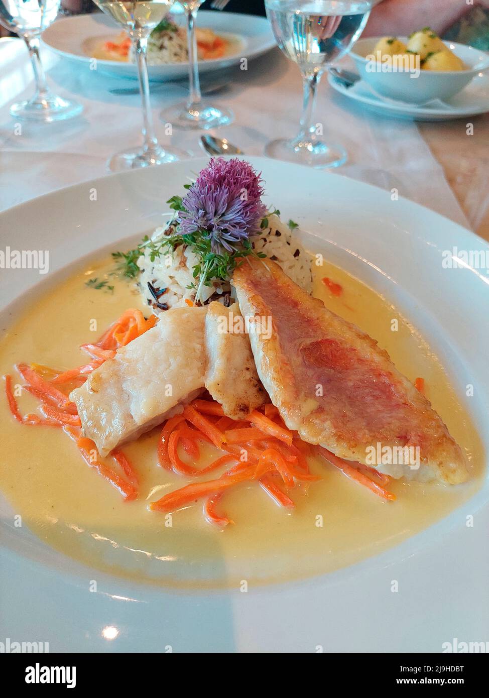 Fried pike perch with rice and saffron sauce Stock Photo - Alamy