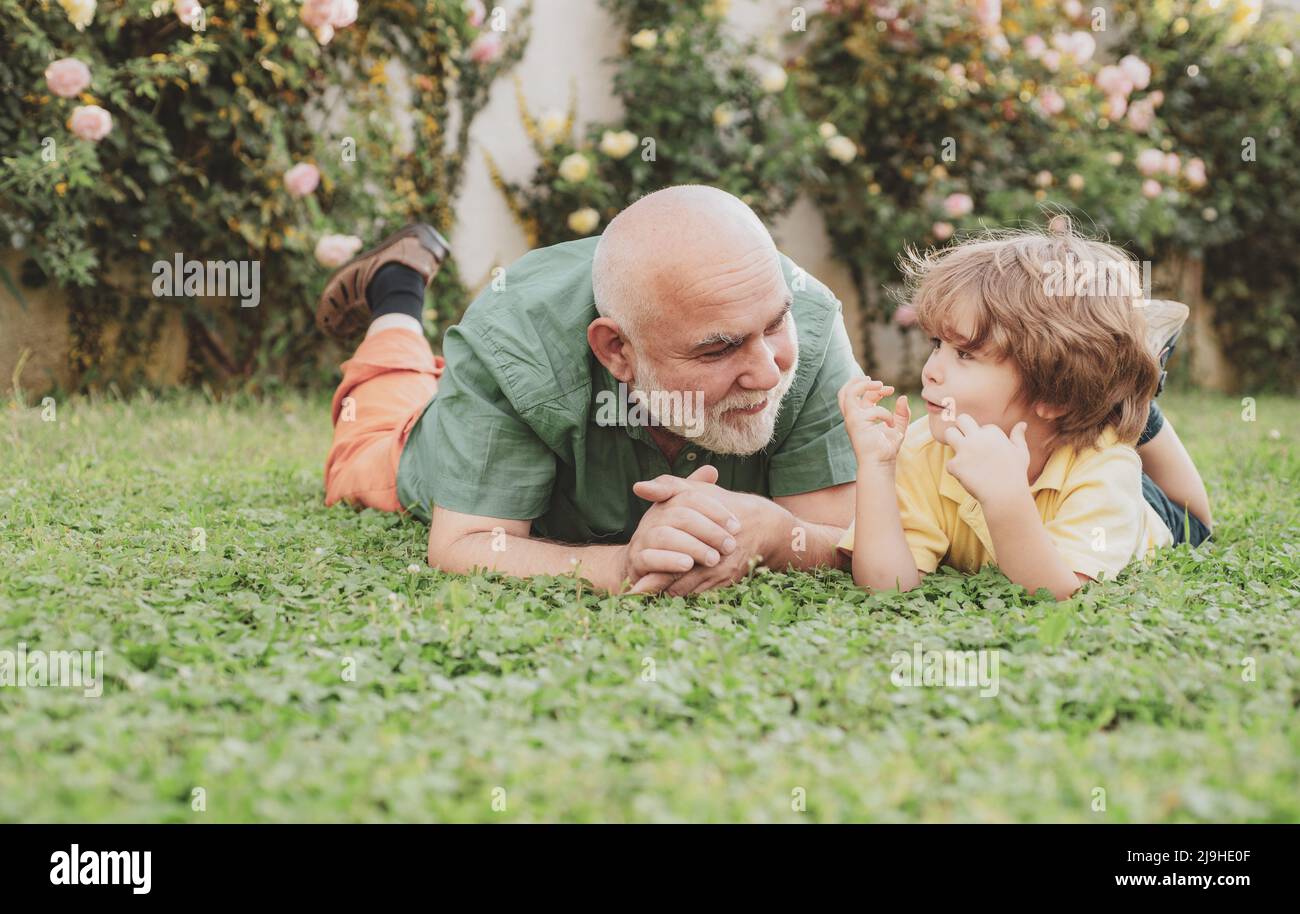 Grandson embrace his grandfather. Happy grandfather and child grandson ...