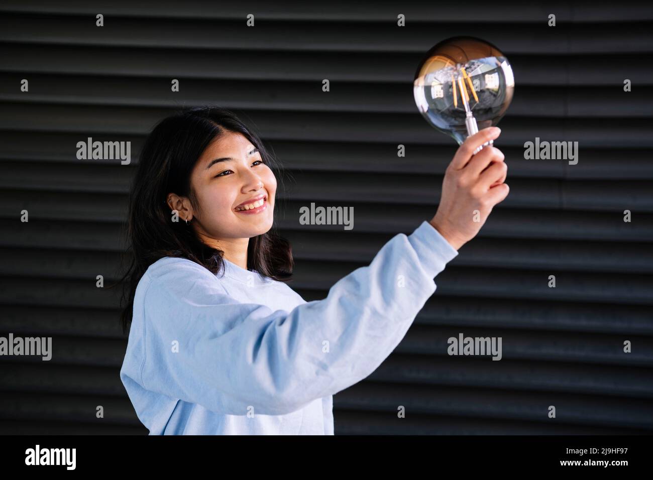 Woman holding bulb hi-res stock photography and images - Alamy