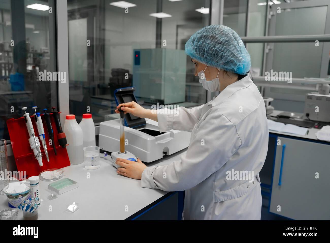 Kazan, Russia. May 10, 2022. Woman scientist testing a flask with a ...