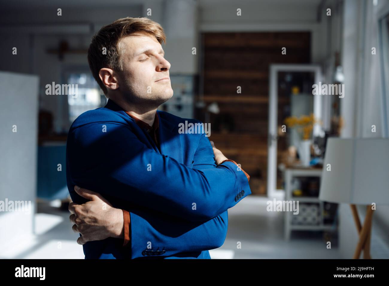 Man hugging himself hi-res stock photography and images - Alamy