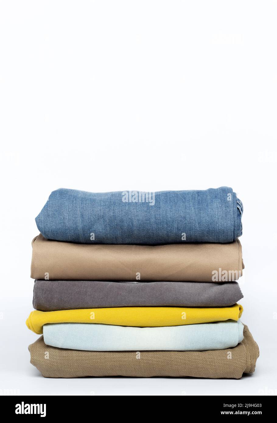 Stack of folded clothes on a white background Stock Photo - Alamy