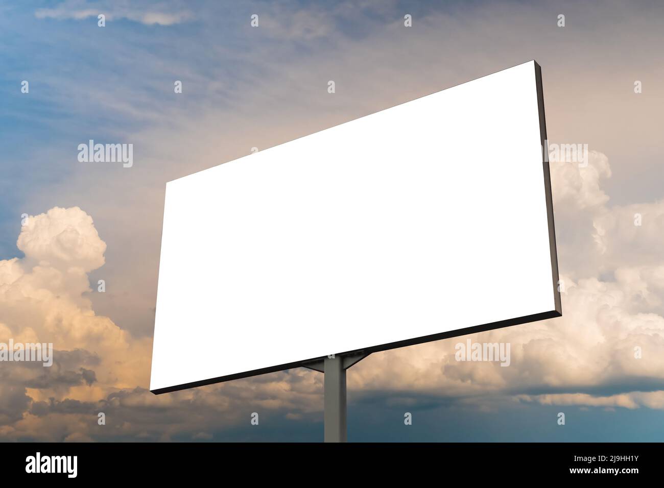 Mock up - blank white billboard against warm sunset sky with clouds ...