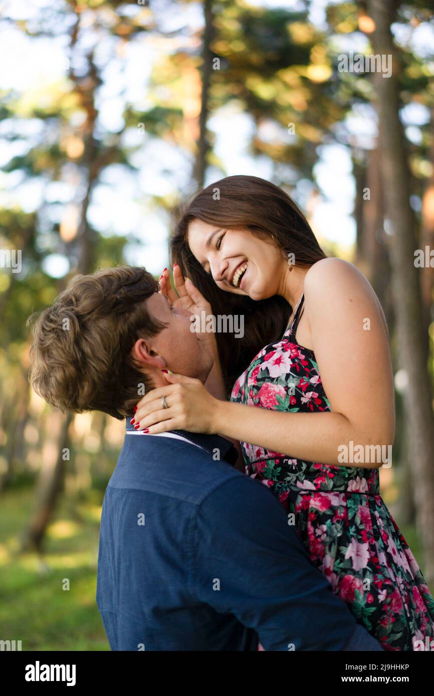 Young man lifting girlfriend enjoying in forest Stock Photo - Alamy