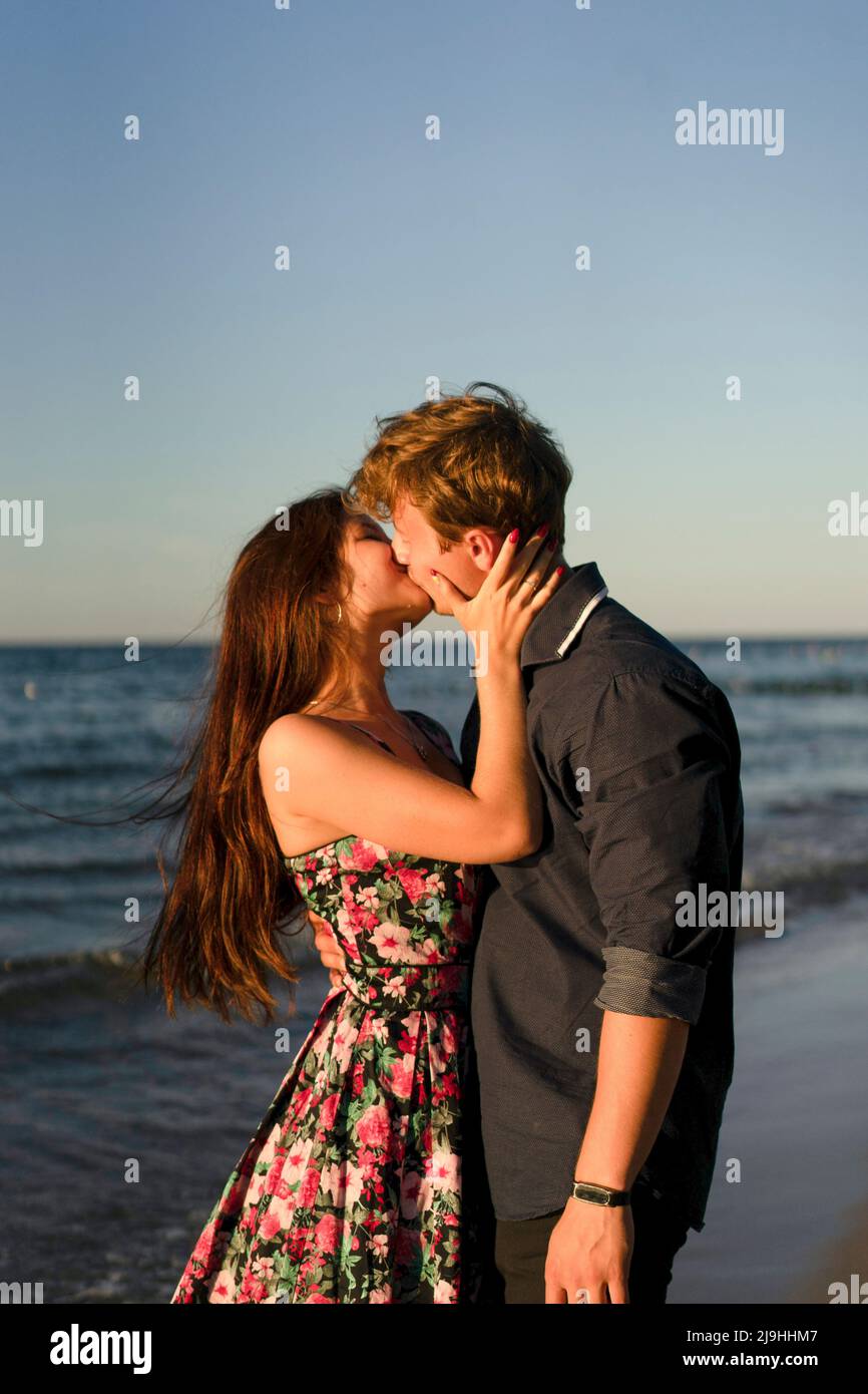 Affectionate couple kissing each other at beach on sunset Stock Photo ...