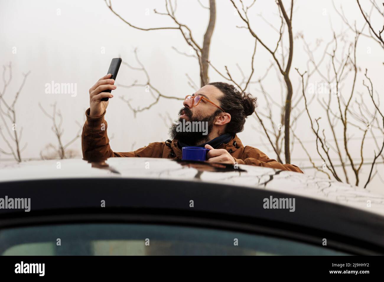 Man standing behind car hi-res stock photography and images - Alamy