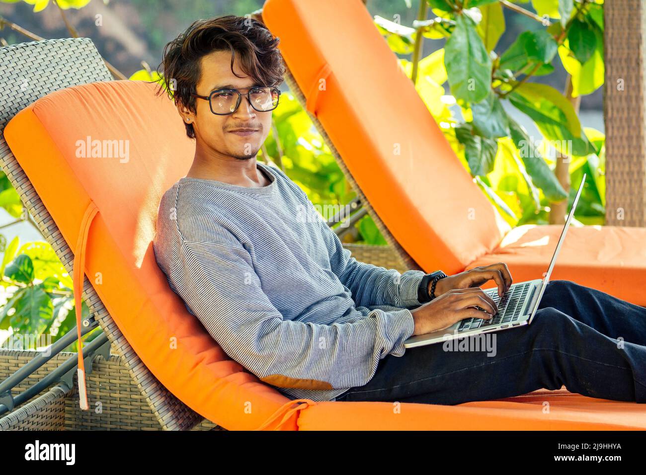 Businessman sitting deck chair laptop hi-res stock photography and ...