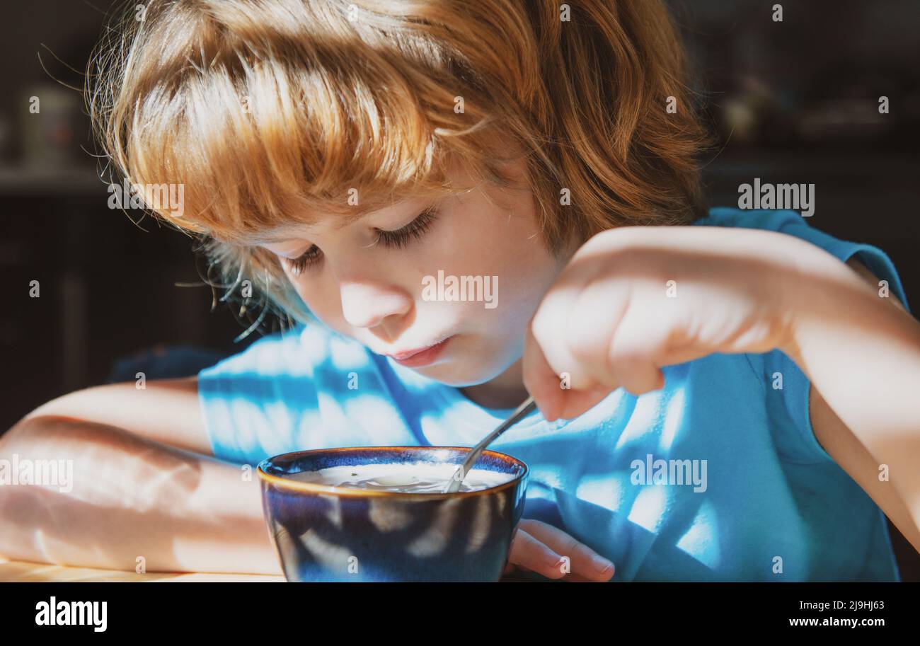 Healthy food for children. Kids nutrition concept. Boy eats at kitchen ...