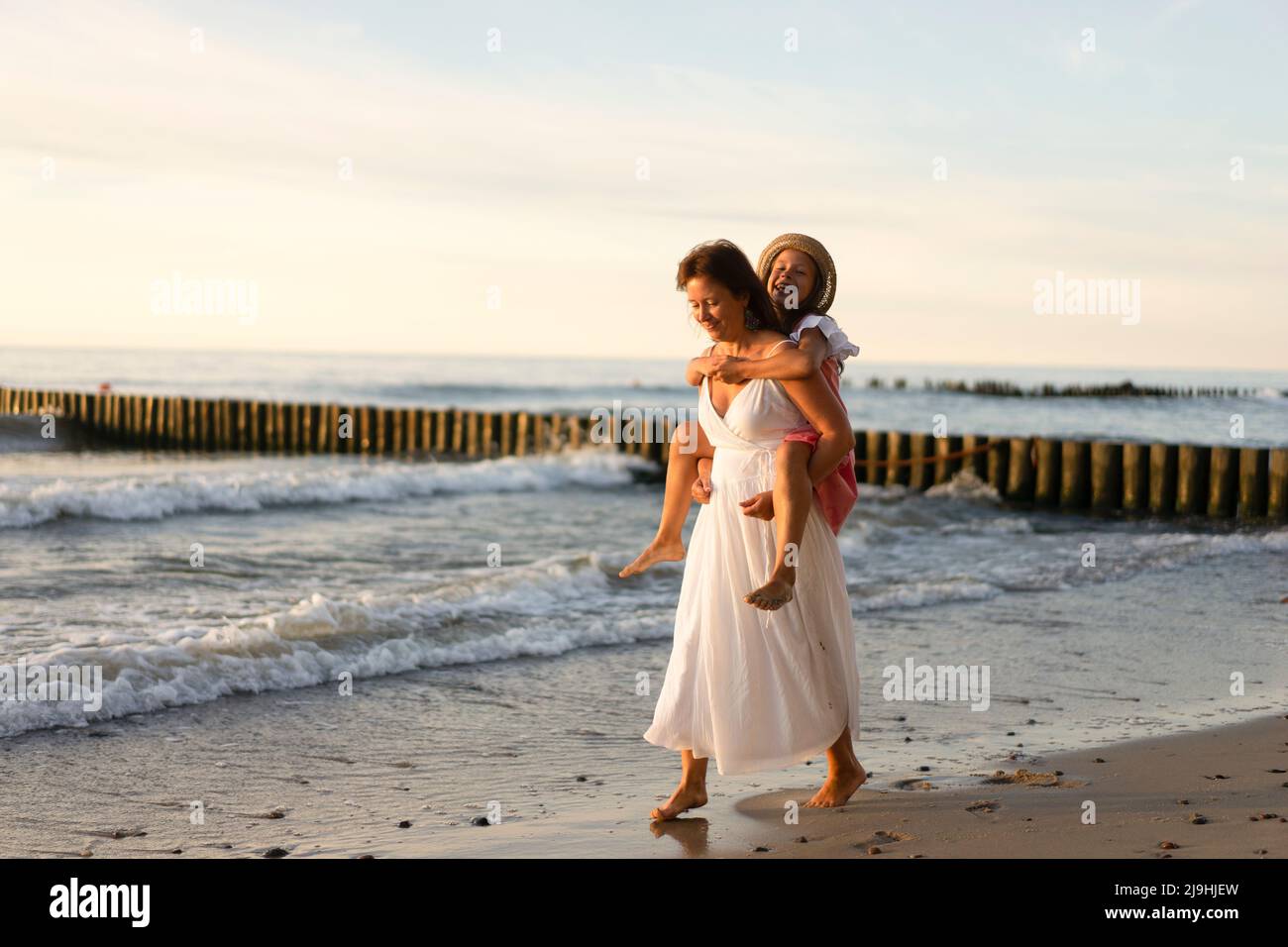 Mother giving piggyback ride hi-res stock photography and images - Alamy