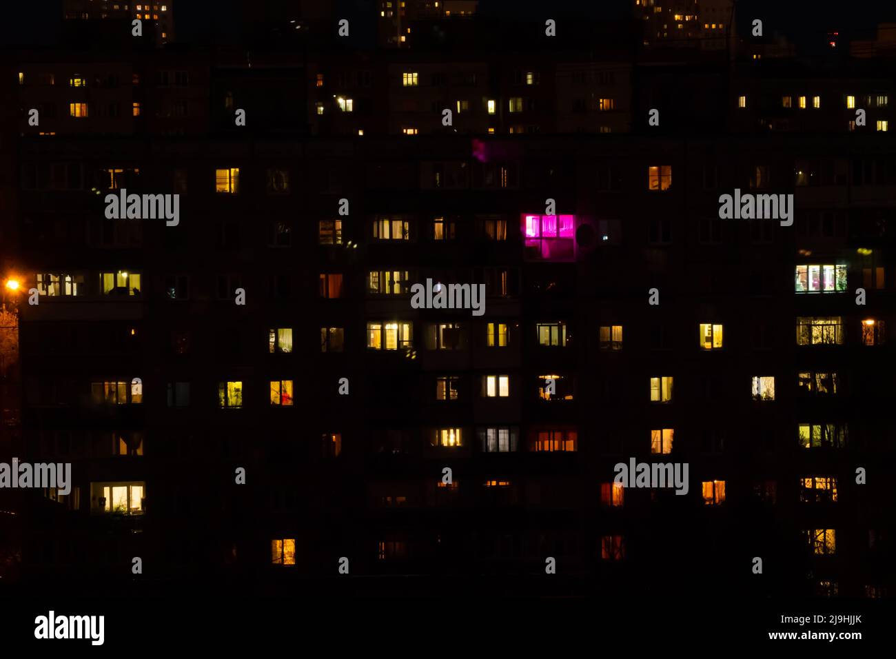Dark apartment building lit window hi-res stock photography and images ...