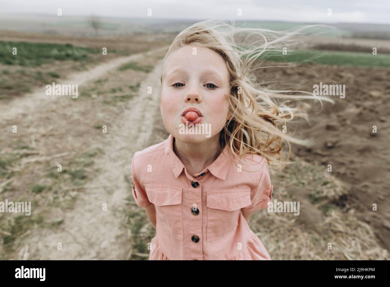 Cheeky girl sticking out her tongue hi-res stock photography and images ...